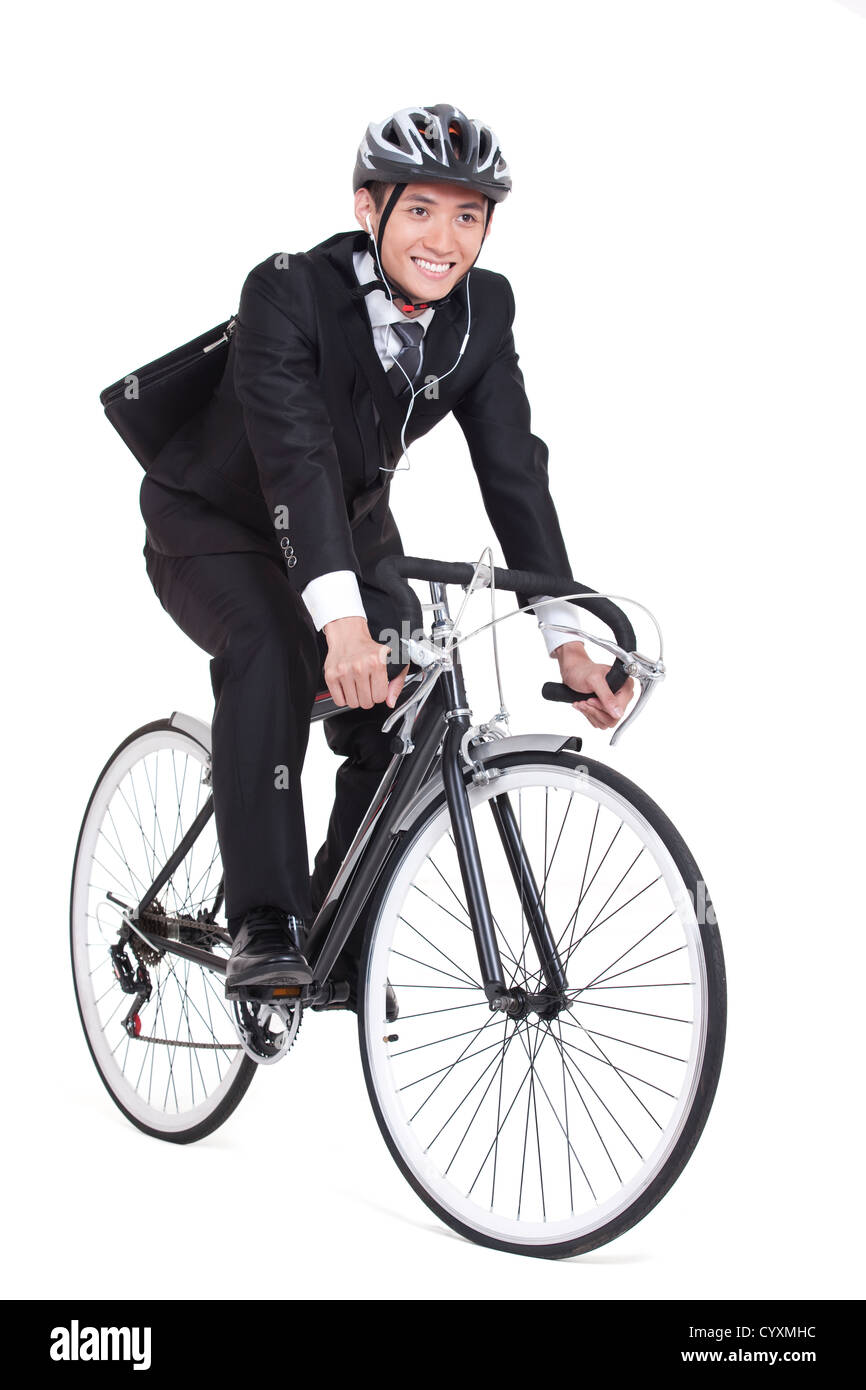 Joyful young businessman riding a bike Stock Photo - Alamy