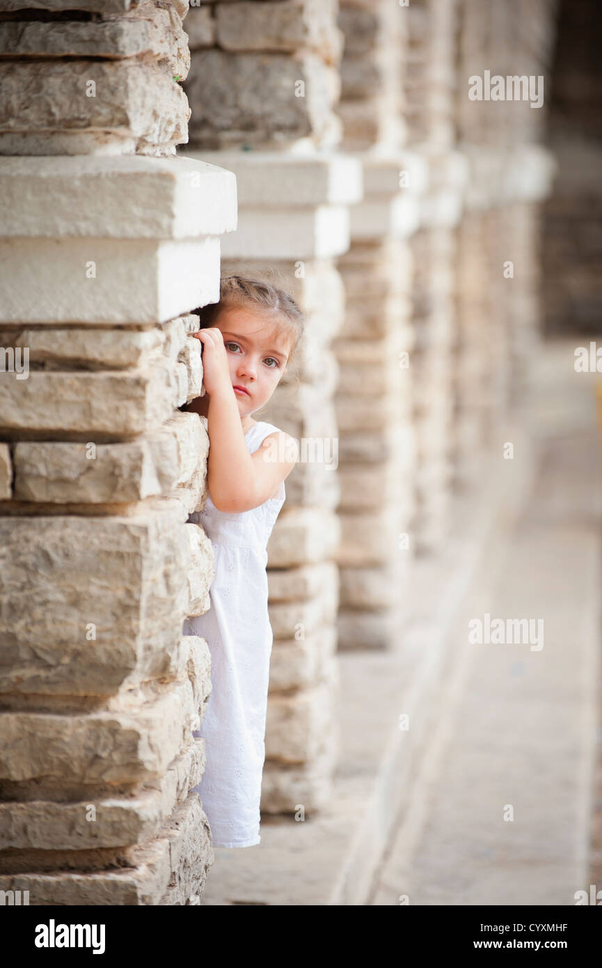 USA, Texas, Girl standing behind column, portrait Stock Photo - Alamy