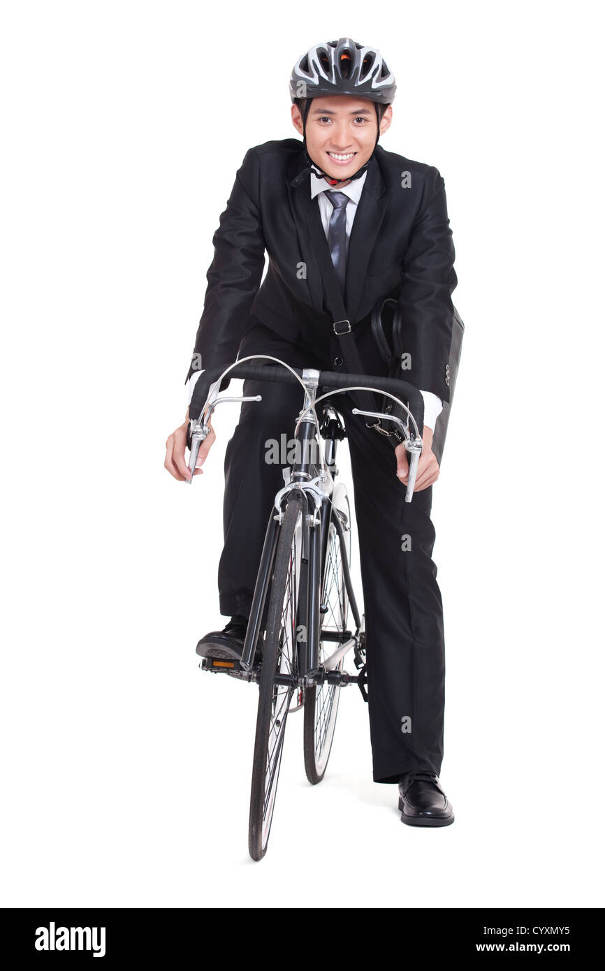 Portrait of young businessman riding a bike Stock Photo - Alamy