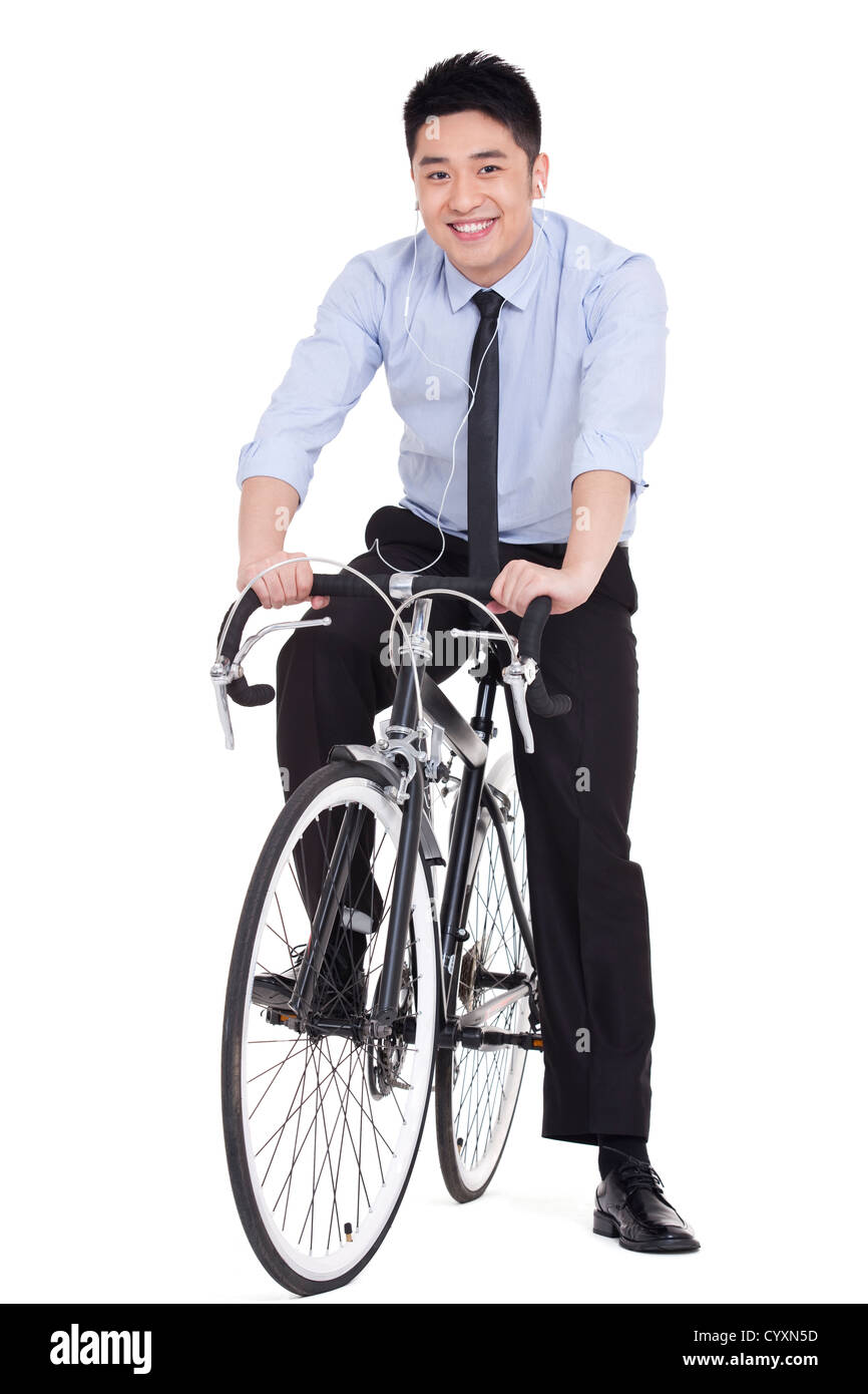 Cool young businessman riding a bike Stock Photo - Alamy