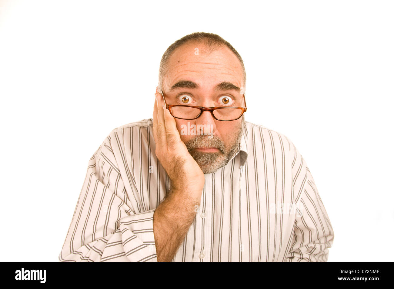 Shocked man looking over the top of his reading glasses Stock Photo - Alamy
