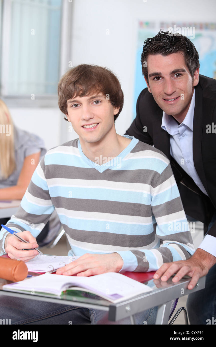 Teacher behind student Stock Photo - Alamy
