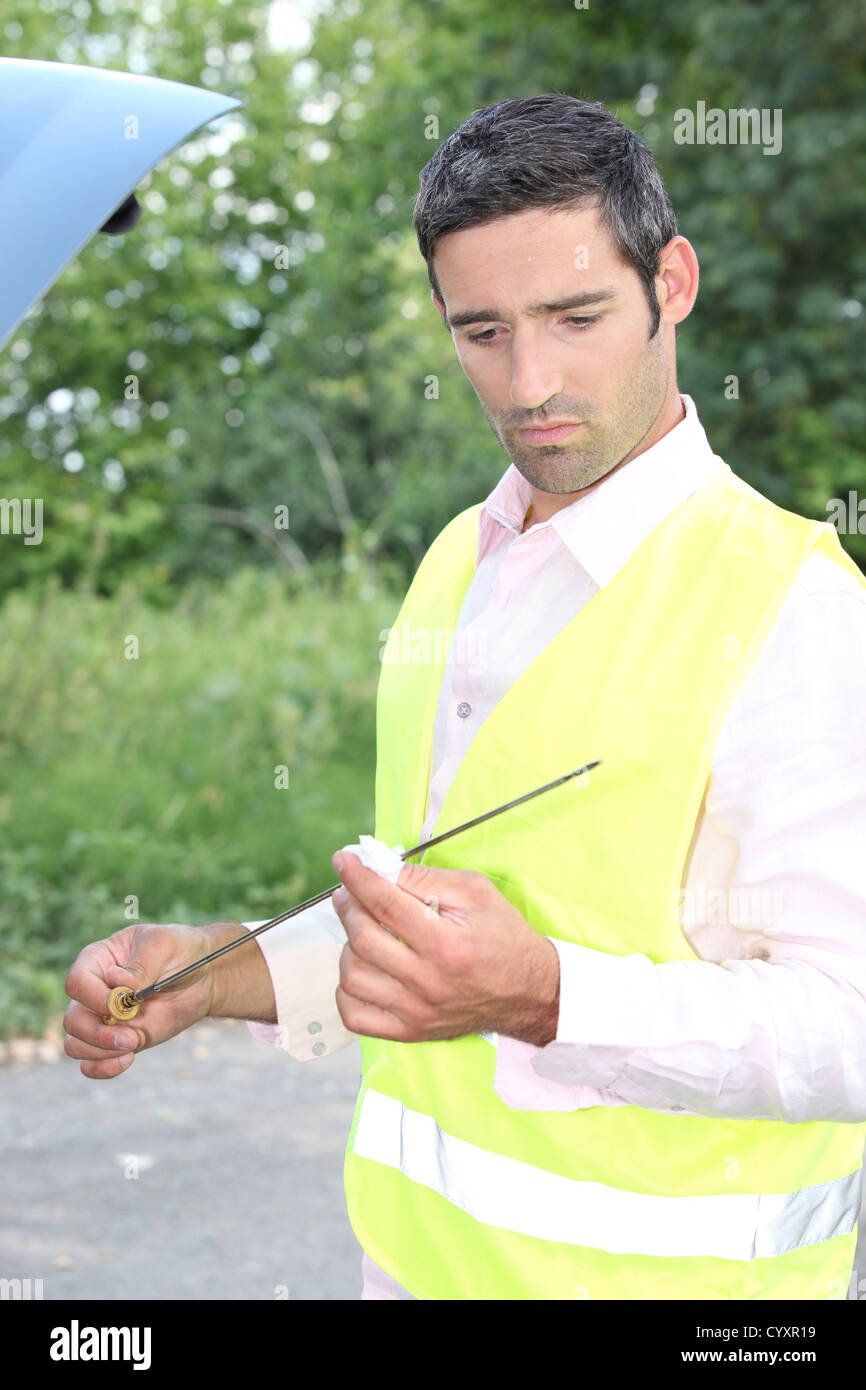 Man checking his oil dipstick Stock Photo - Alamy