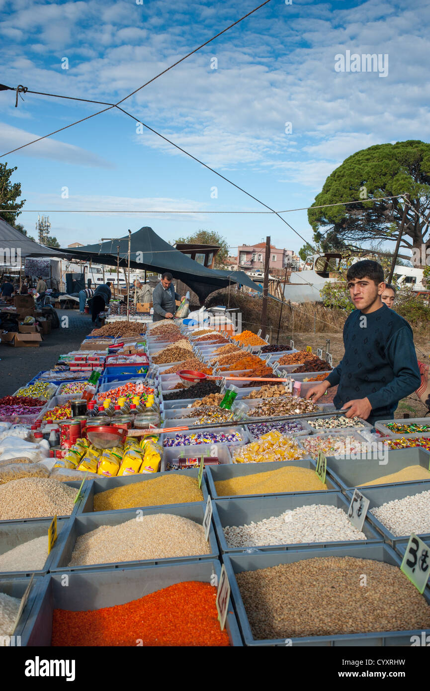 Market stall holder mans his stall in Foca, Turkey with a range of ...