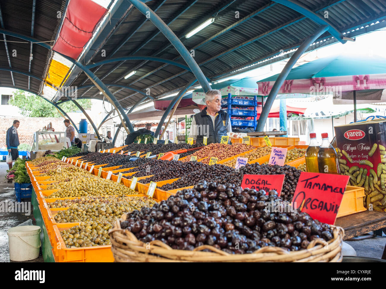 Stall holder at the weekly market in Foca, Turkey selling various ...