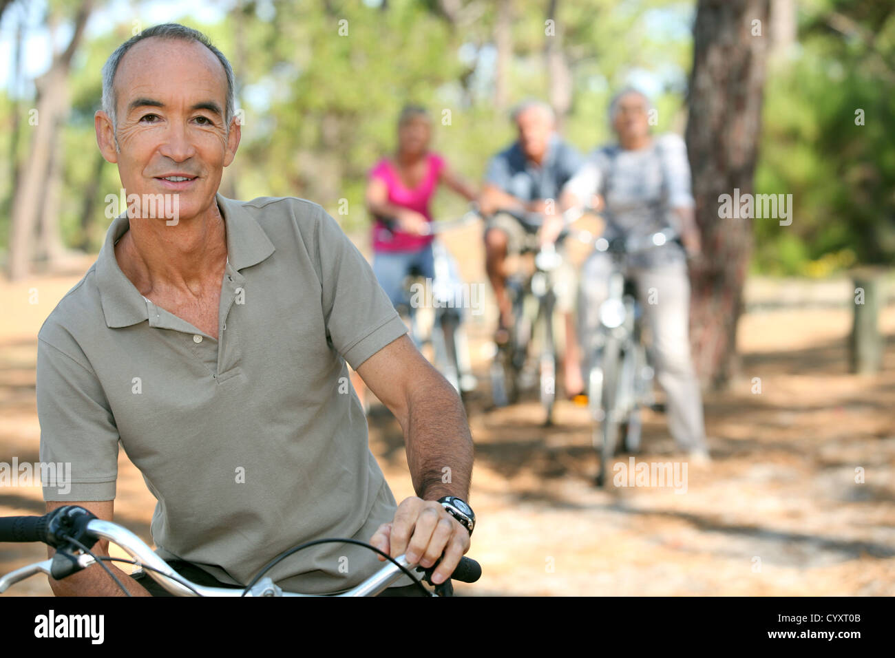 Elderly man riding bicycle bike ride exercise park cycle hi-res stock ...