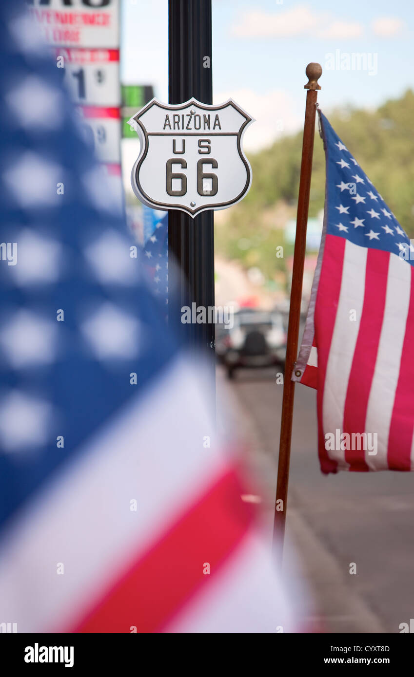 Route 66 sign on side of road with American flags Stock Photo - Alamy