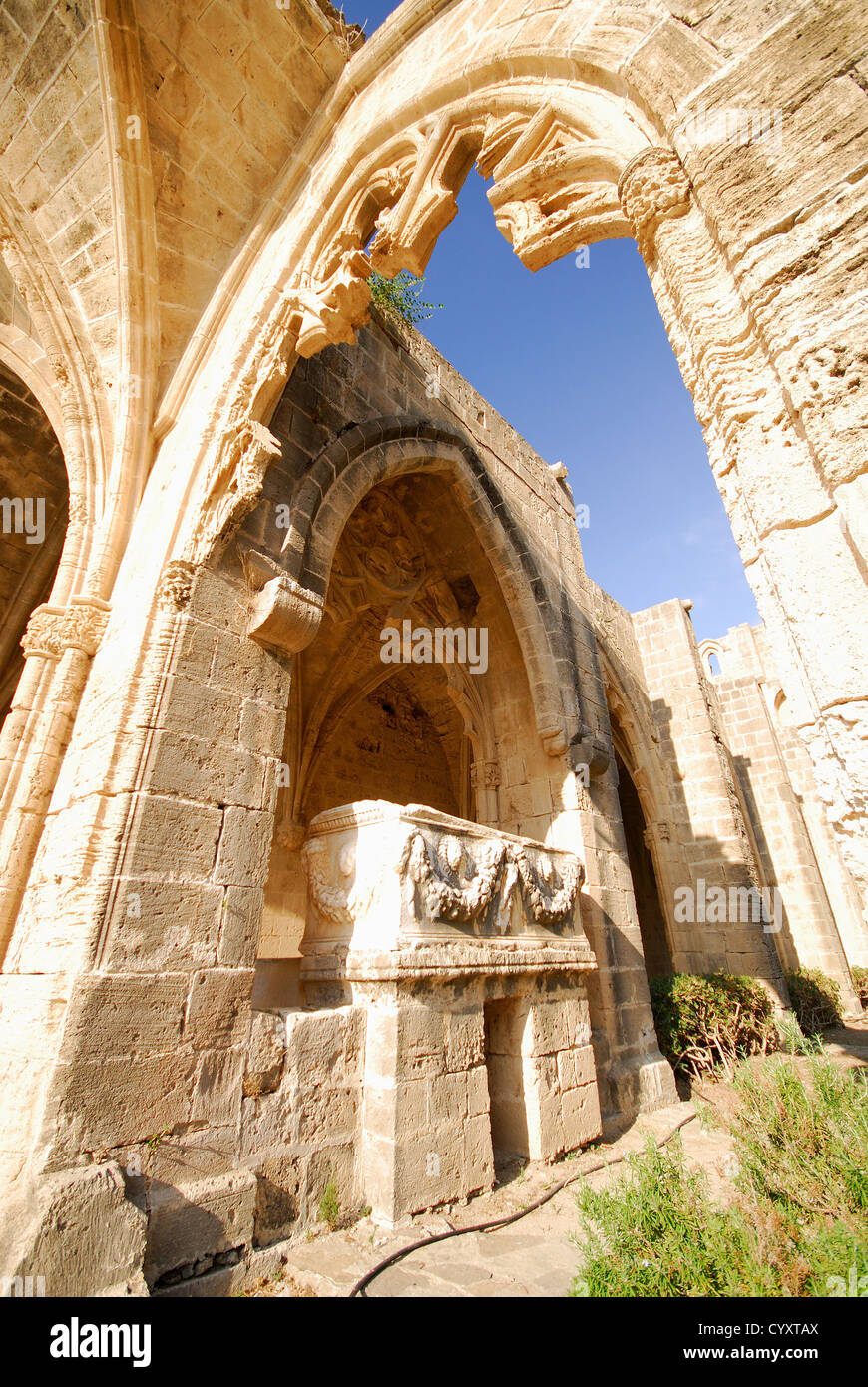 NORTH CYPRUS. An arched window and stone sarcophagus in the ruins of ...