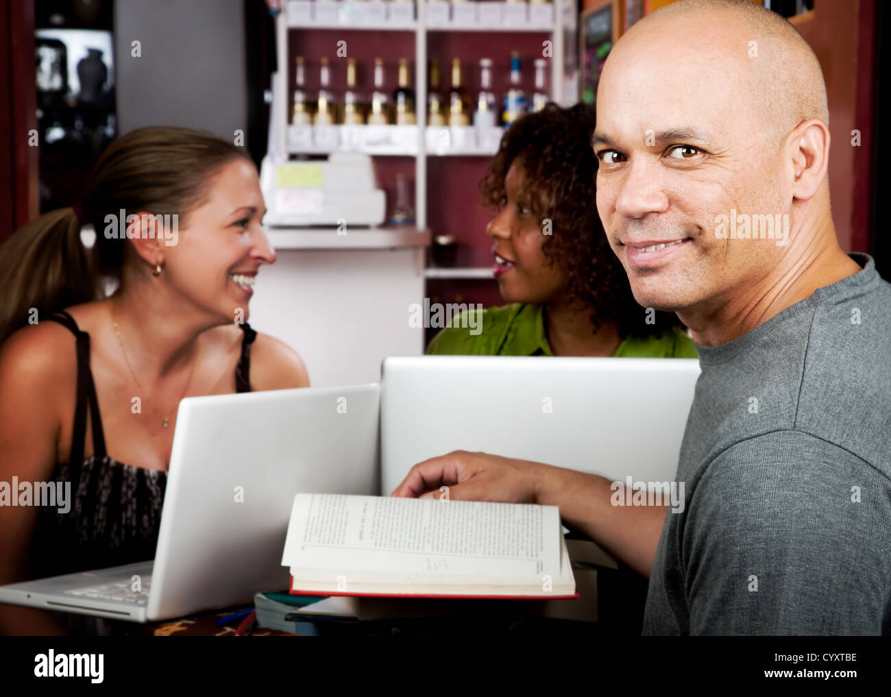 Diverse adult study group in coffee house Stock Photo - Alamy