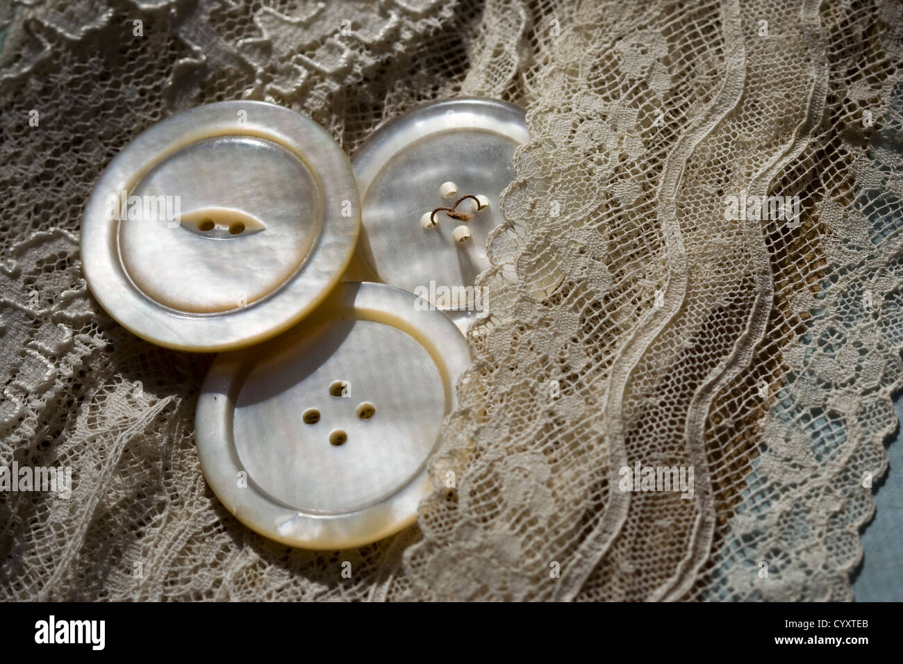 Antique buttons and lace displayed in some beautiful natural window ...