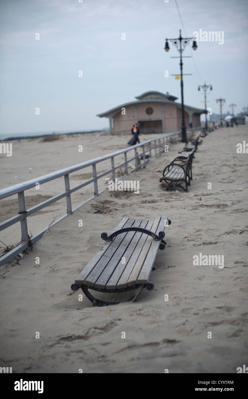 Volunteers clean up debris and sand deposited by Hurricane Sandy from ...