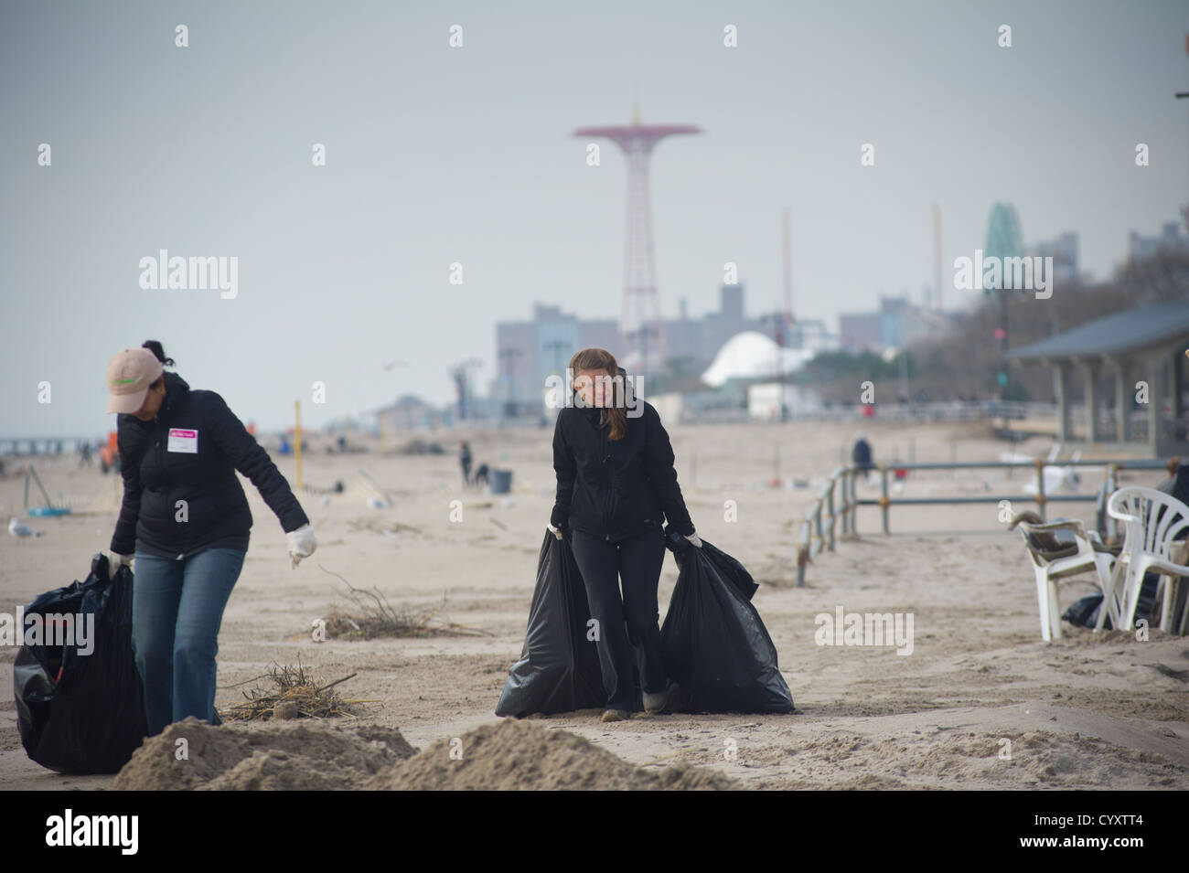 Volunteers clean up debris and sand deposited by Hurricane Sandy from ...