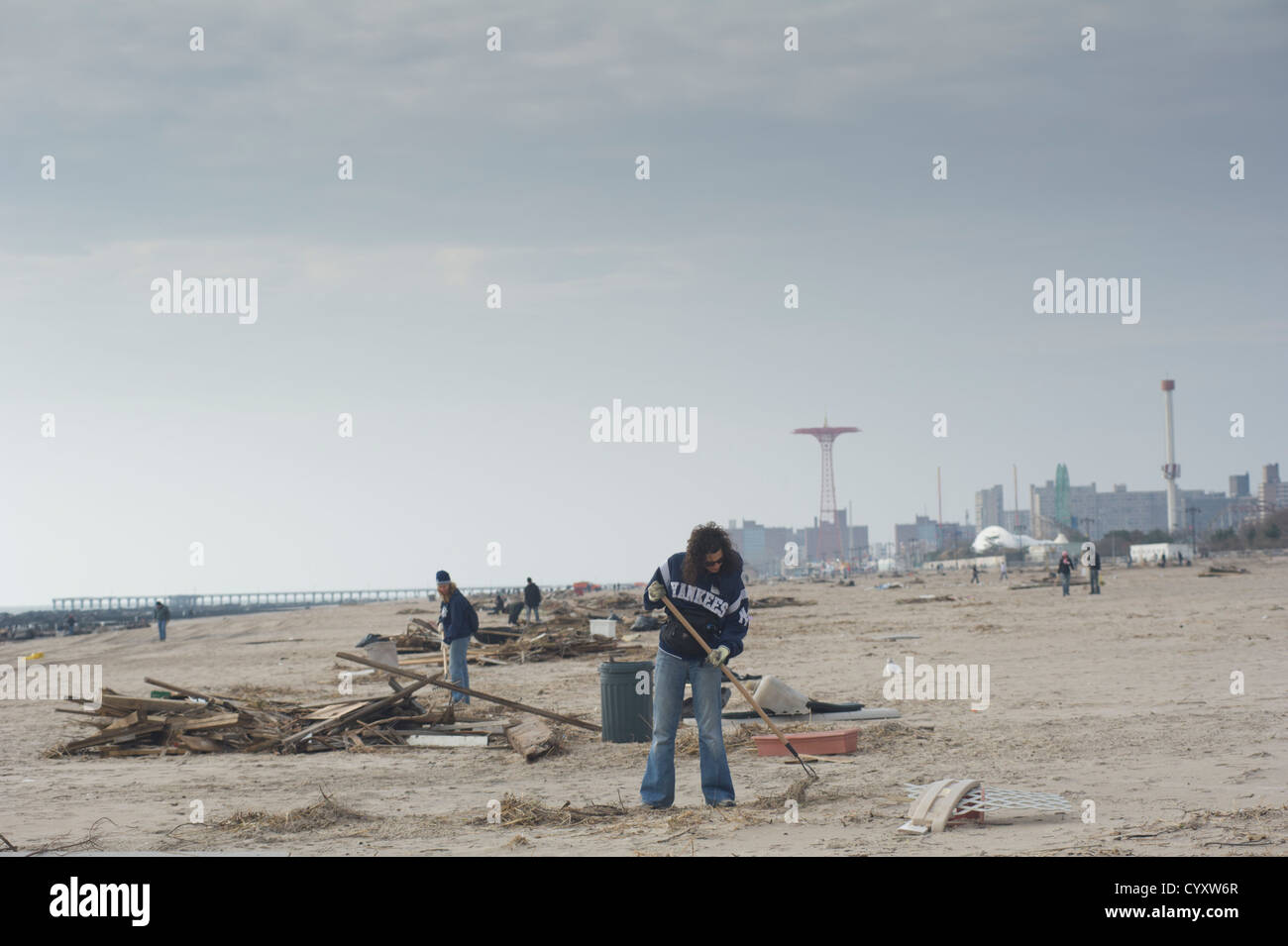 Volunteers clean up debris and sand deposited by Hurricane Sandy from ...