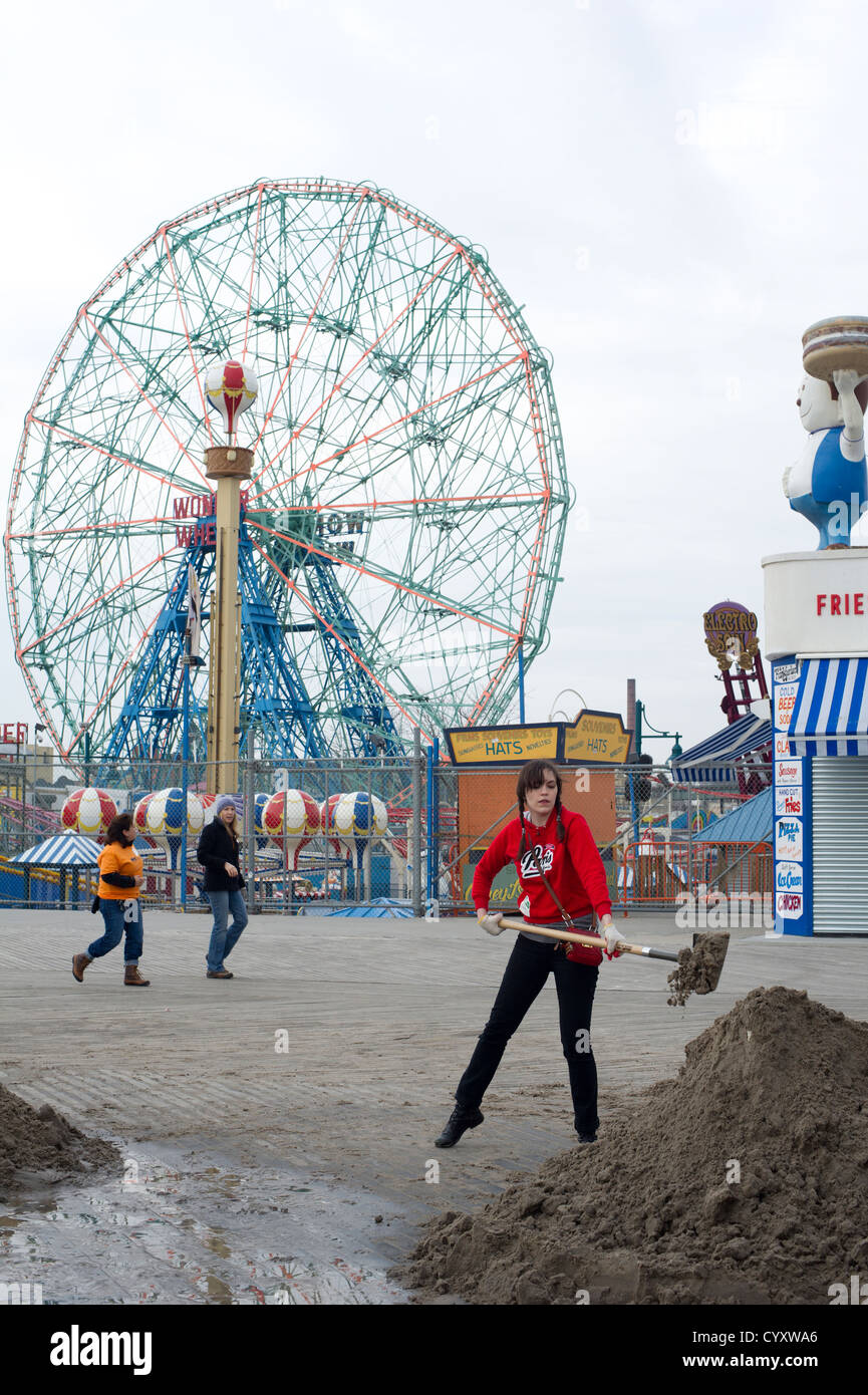 Volunteers clean up debris and sand deposited by Hurricane Sandy from ...