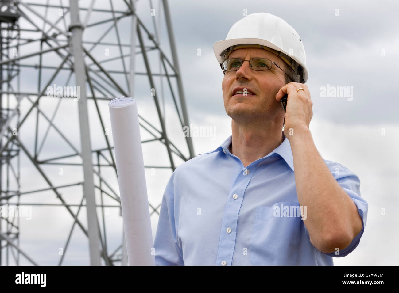 Engineer talking on mobile phone on construction side Stock Photo - Alamy