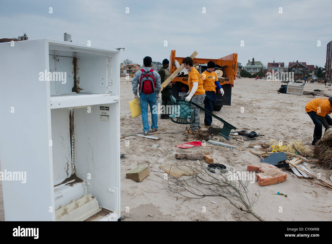 Volunteers clean up debris and sand deposited by Hurricane Sandy from ...