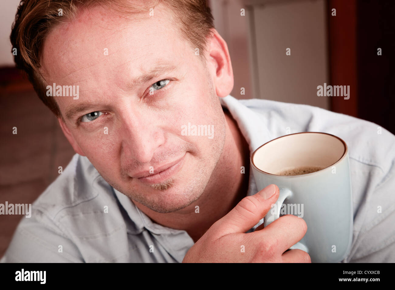 Portrait of handsome man with coffee mug Stock Photo - Alamy