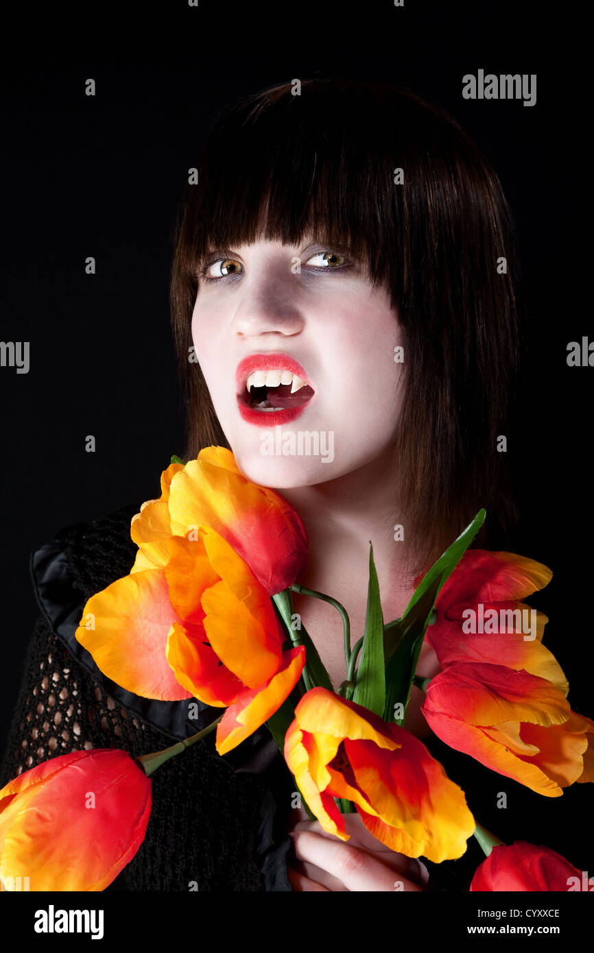 Pretty young vampire with bright plastic flowers Stock Photo - Alamy