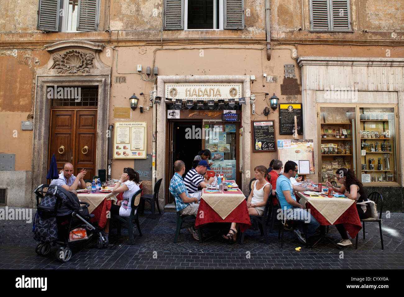 Diners eating al at restaurant in back street hi-res stock photography ...