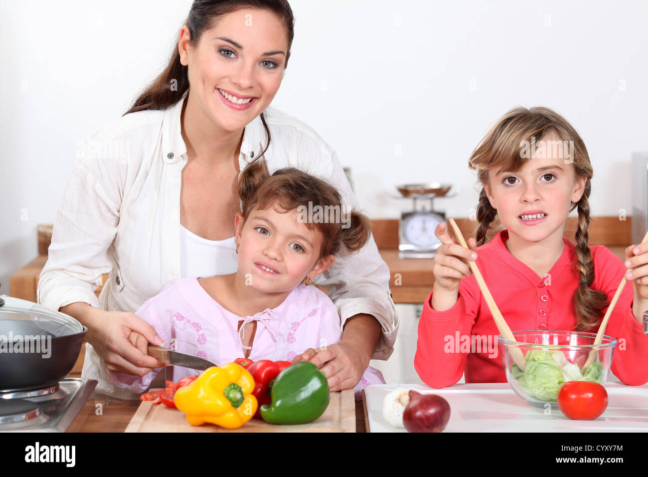 Children preparing a meal with mum Stock Photo - Alamy