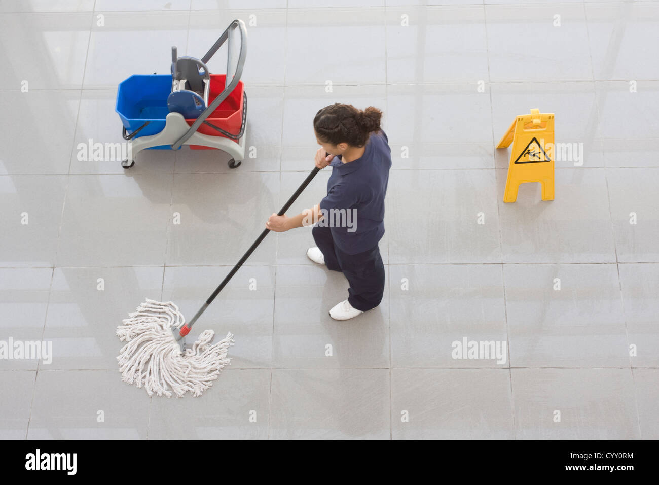 A worker is cleaning the floor with equipment Stock Photo - Alamy