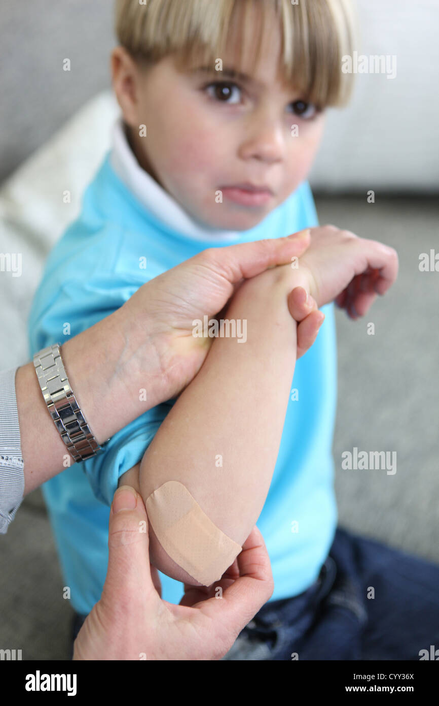 Little boy with a bandage on arm Stock Photo - Alamy