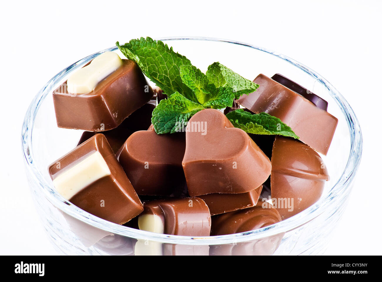 Glass bowl of assorted chocolates and mint Stock Photo - Alamy