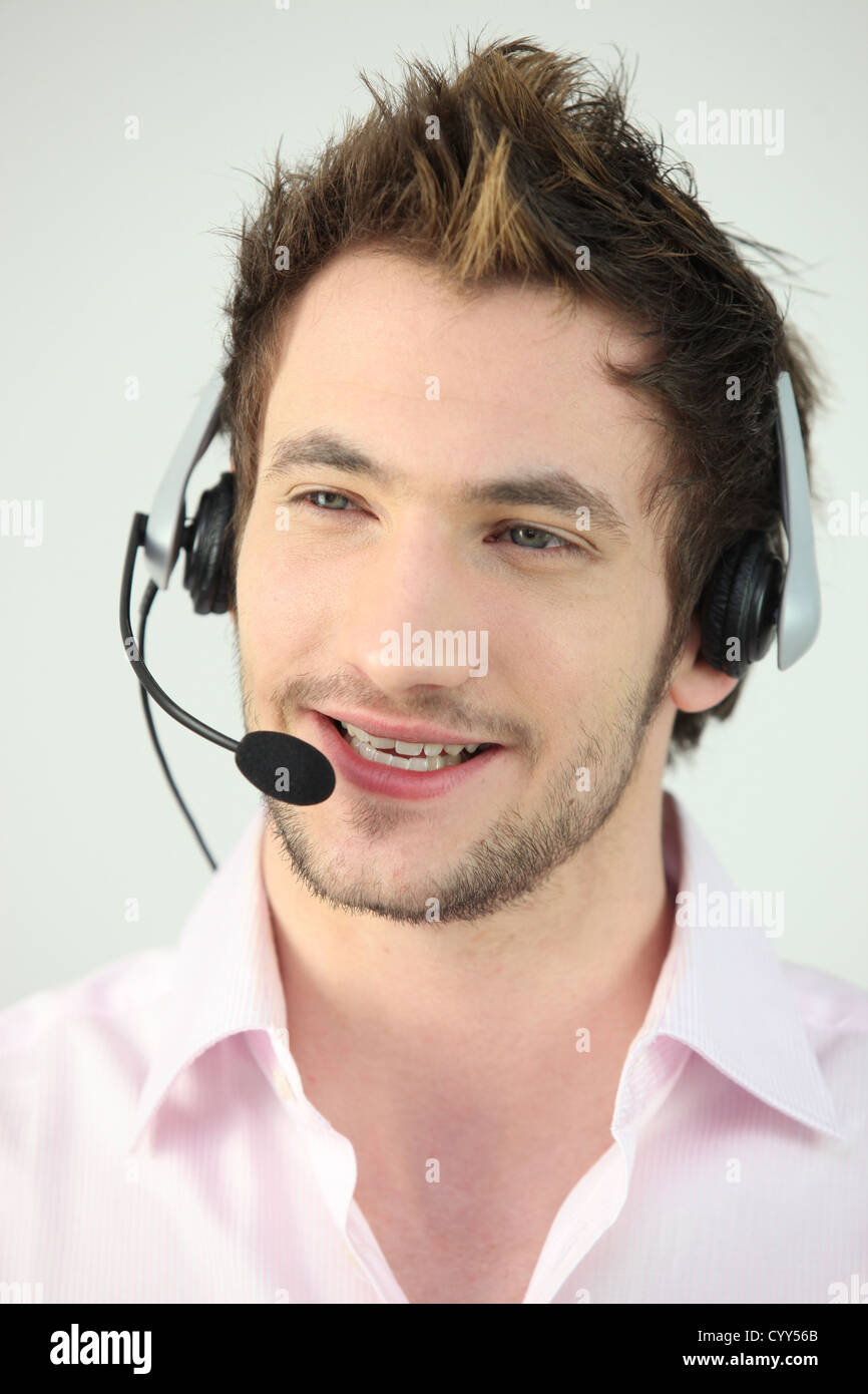 Attractive man speaking into a headset Stock Photo - Alamy