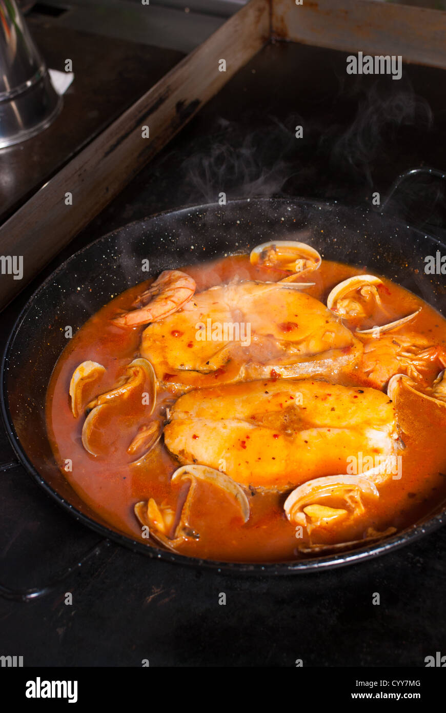 Traditional Spanish hake in cider sauce being cooked Stock Photo - Alamy