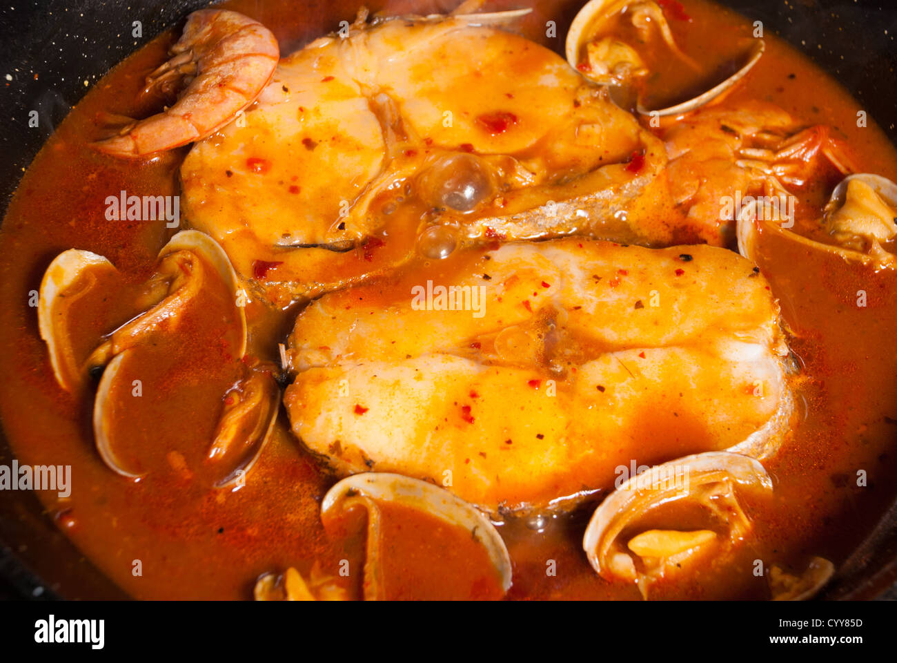 Cooking hake in cider sauce, a traditional Spanish recipe Stock Photo ...
