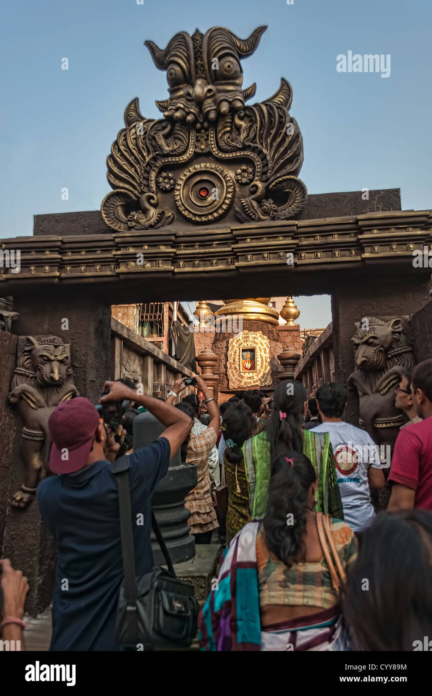 Crowd entering a pandal, temporary bamboo structure represents a temple ...