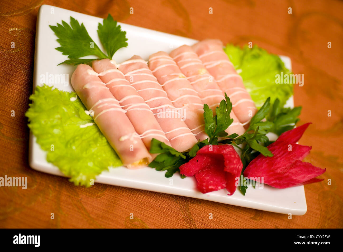 ham rolls on plate with lettuce macro shot Stock Photo - Alamy