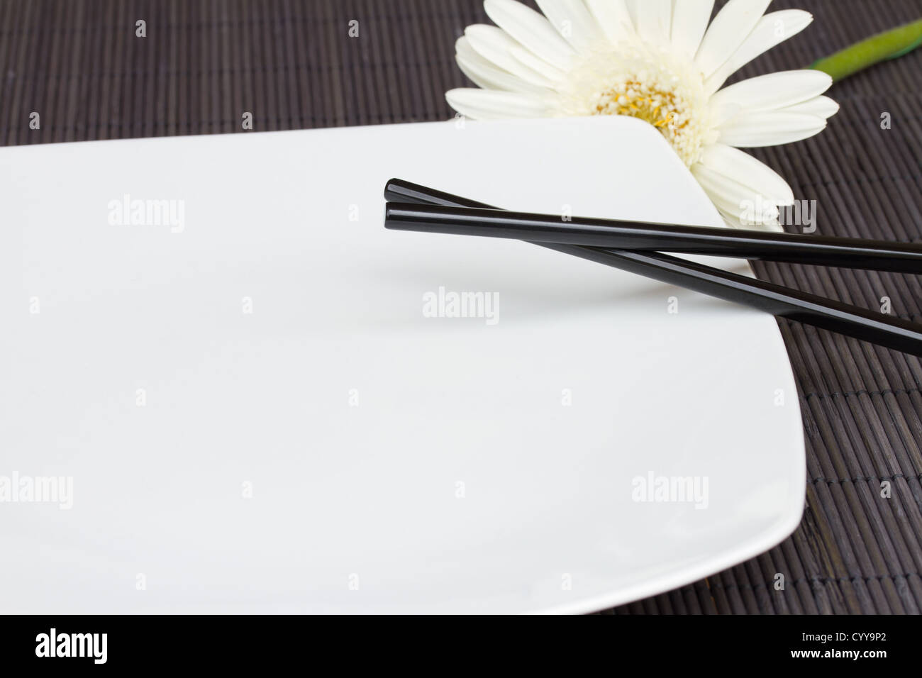 asian food concept - empty plate with chopsticks Stock Photo - Alamy