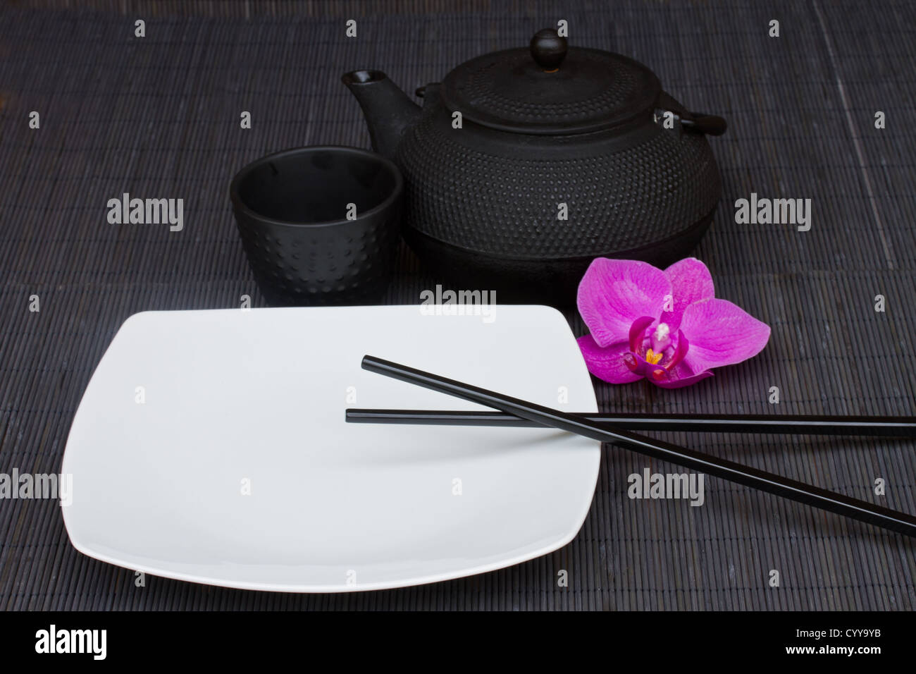 asian food concept - empty plate with chopsticks and tea set Stock ...
