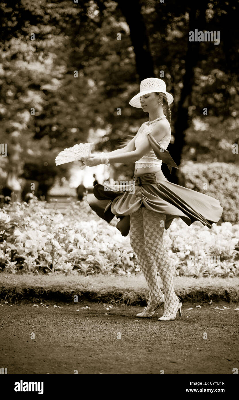 Young woman dancing with fan outdoors greyscale Stock Photo - Alamy