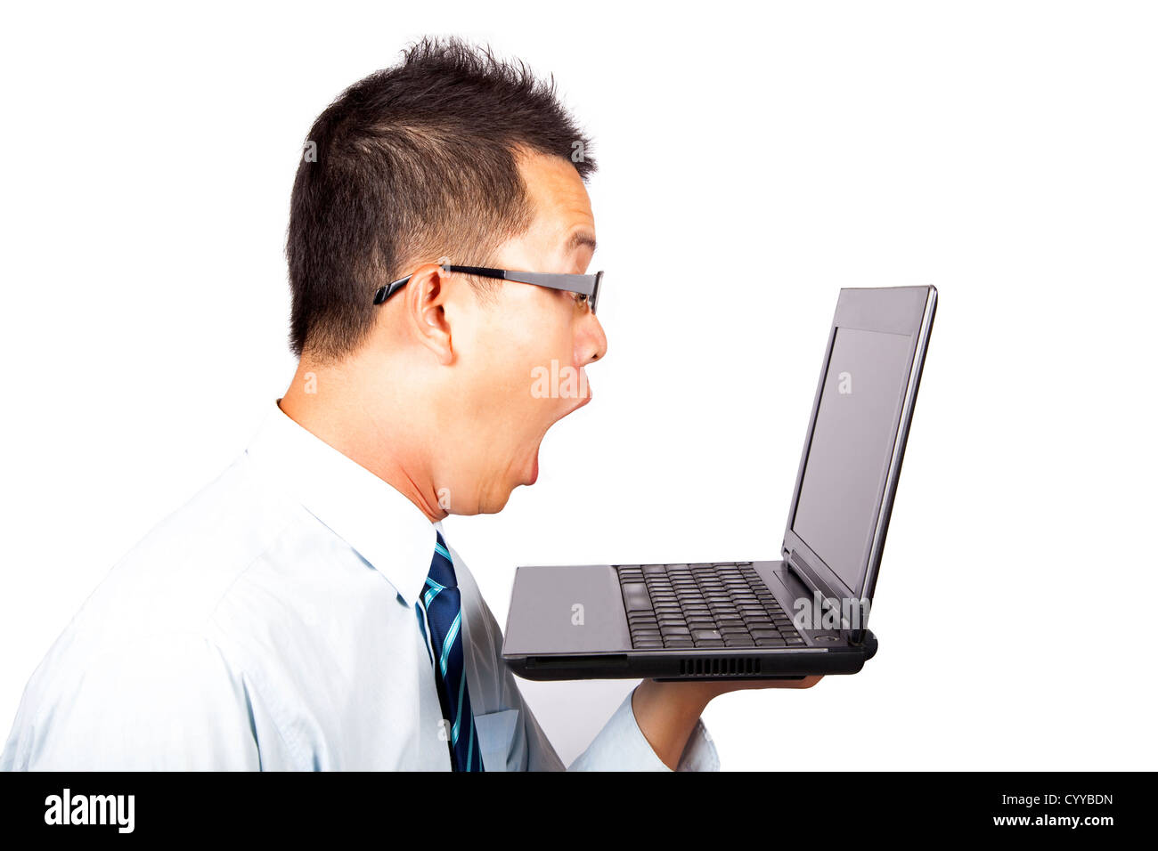 Surprised businessman with computer Stock Photo - Alamy