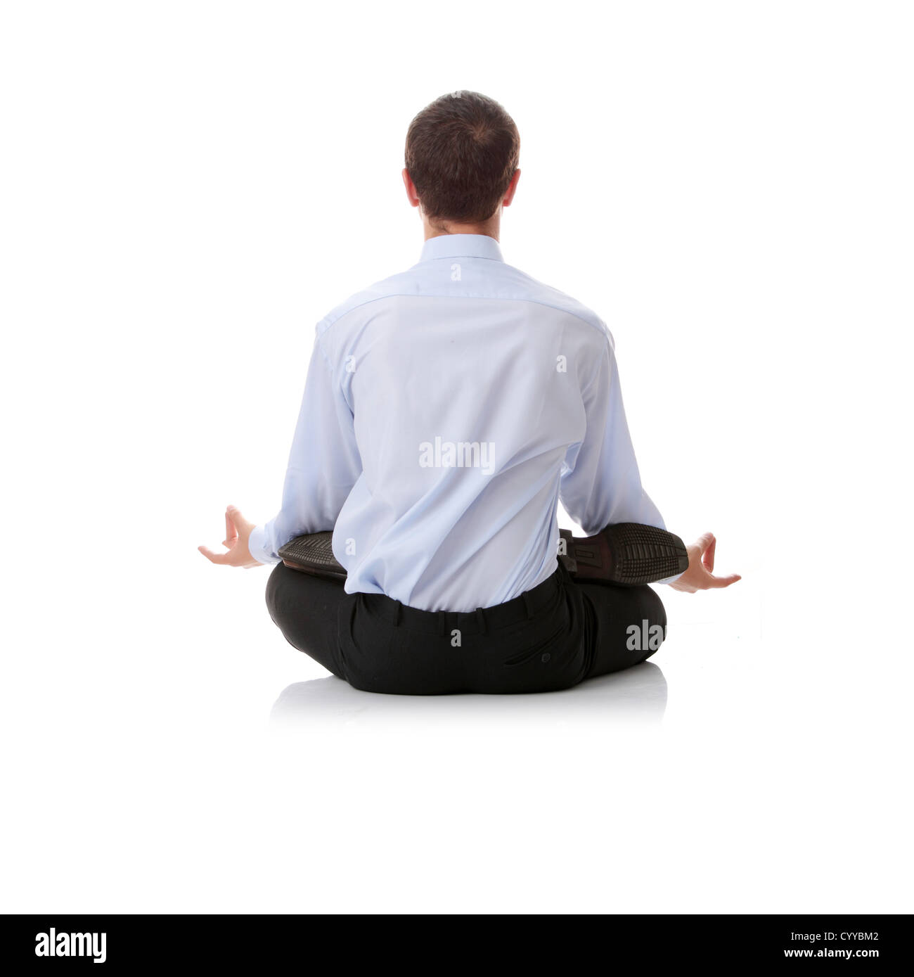 Businessman sitting in lotus position, Isolated against white ...