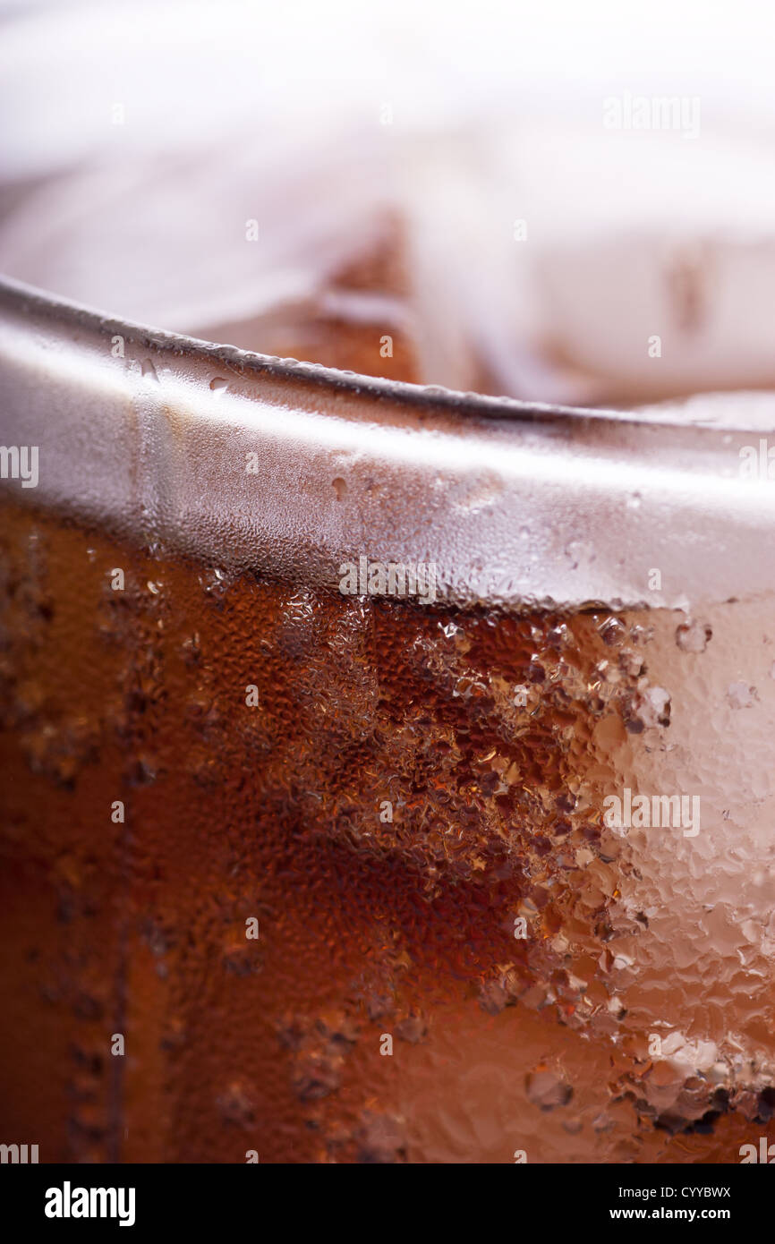 Cold cola in a glass with ice cubes. Macro view Stock Photo - Alamy