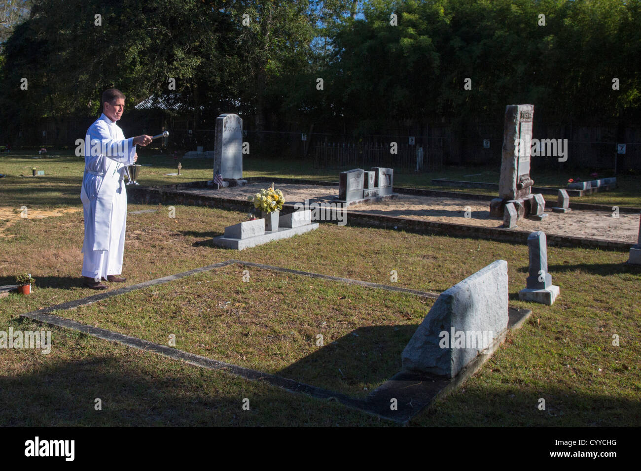 Deacon Steve Ferran sprinkles holy water during Blessing of the Graves Stock Photo - Alamy