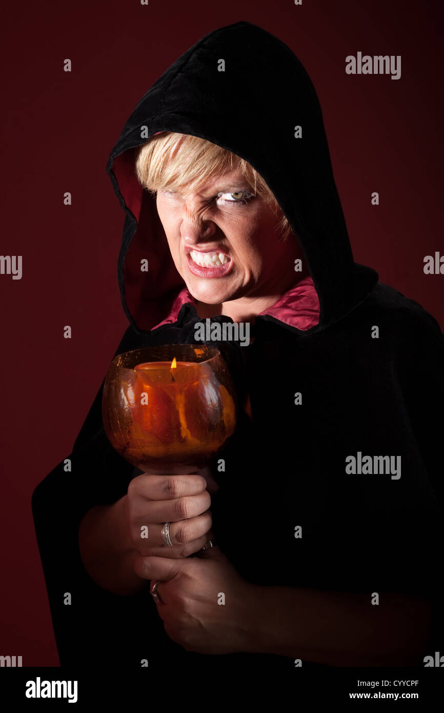 Scary witch with teeth clenched and candle Stock Photo - Alamy