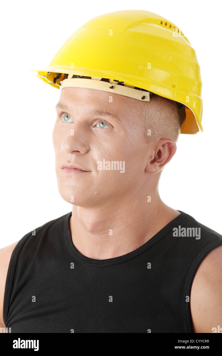 Young handsome builder in yellow helmet. Isolated over white background ...