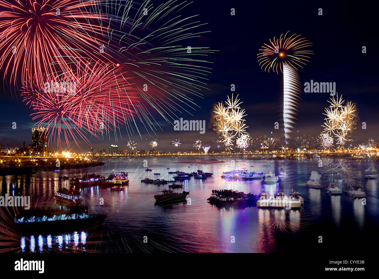 Fire works firing up into the sky with a boat on a river below them ...