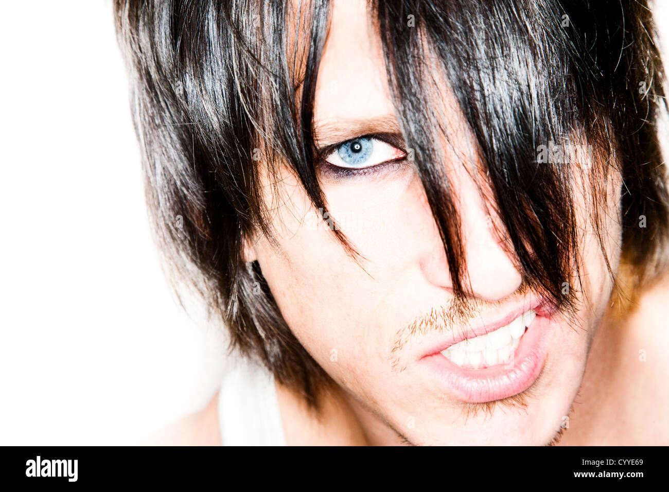 Closeup of handsome young man with sneering expression Stock Photo - Alamy