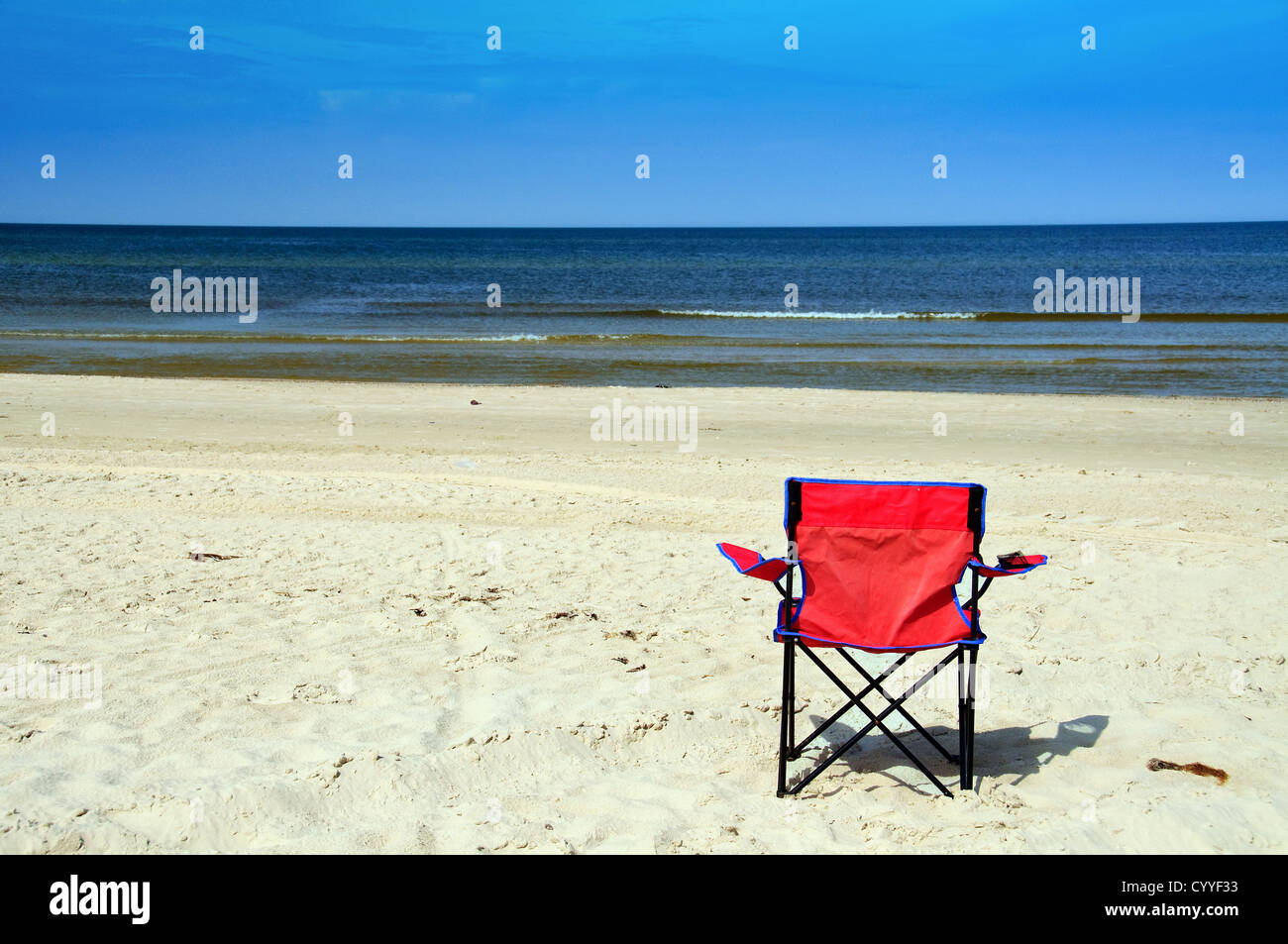 A red beach chair facing the sea Stock Photo - Alamy