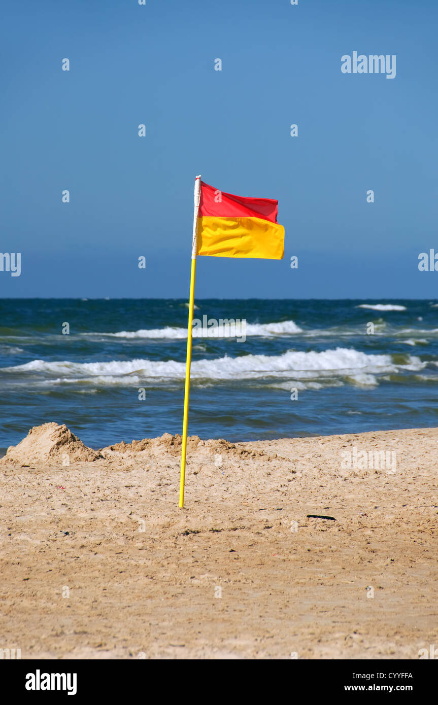 A lifeguard flag on the beach Stock Photo - Alamy