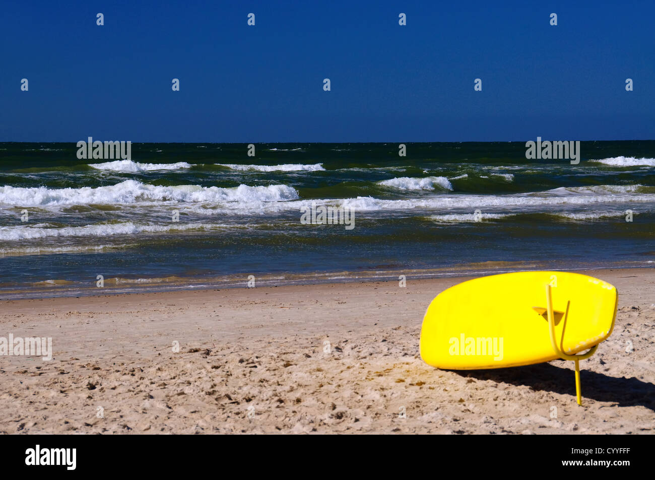 A yellow rescue surf board on the beach Stock Photo - Alamy