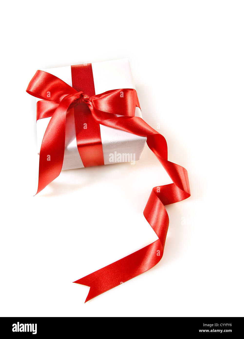 Gift box wrapped with red satin ribbon on white Stock Photo - Alamy