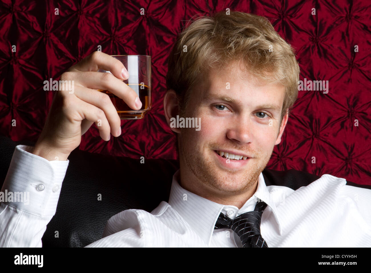 Young man drinking alcohol Stock Photo - Alamy