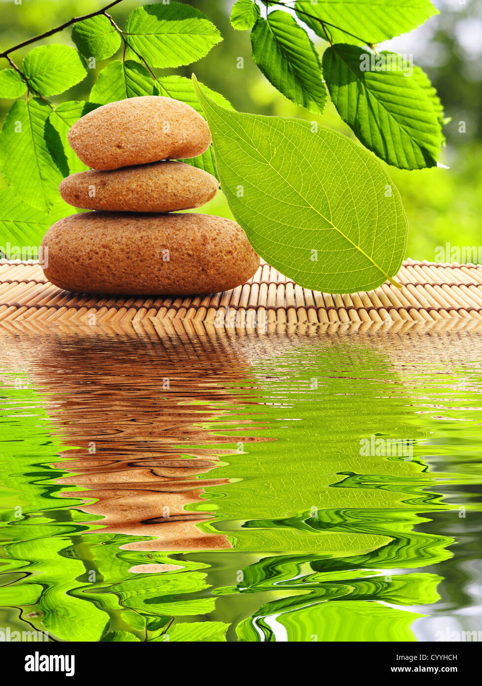 zen stones and water reflection showing spa concept Stock Photo - Alamy
