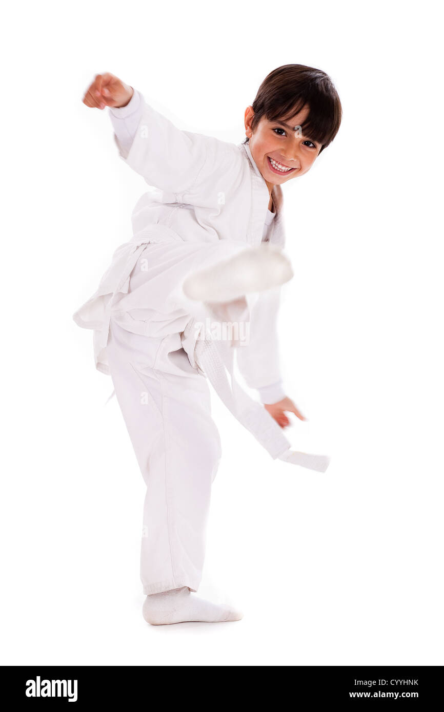 Karate kid kicking over isolated white background Stock Photo - Alamy
